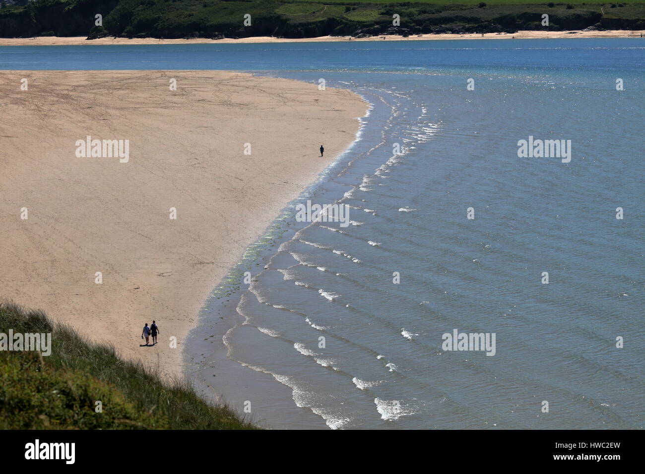 Wavelets and walkers along beach as tide rises in the River Camel ...