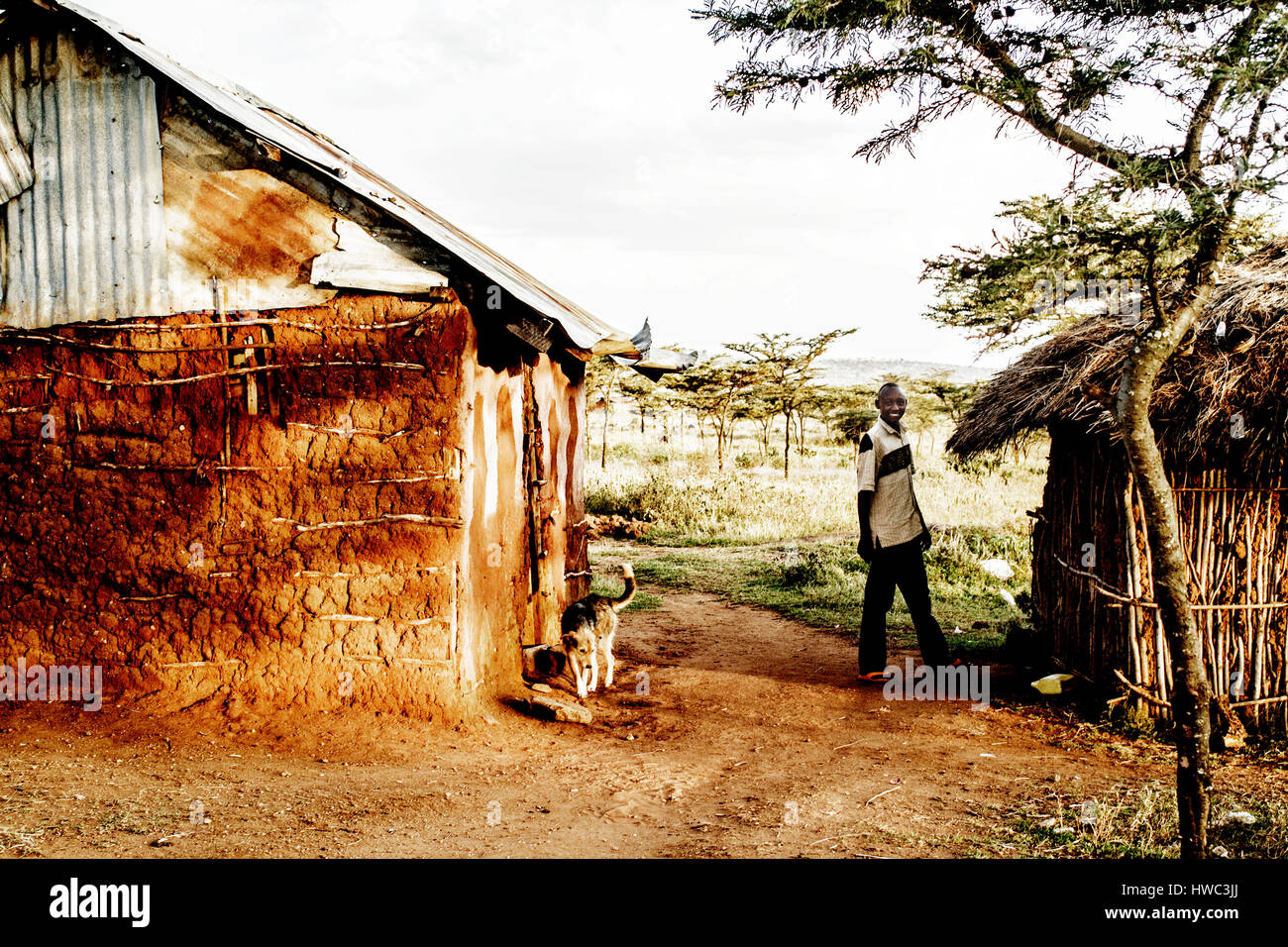 A smiling young man in a rural community, Kenya Stock Photo - Alamy