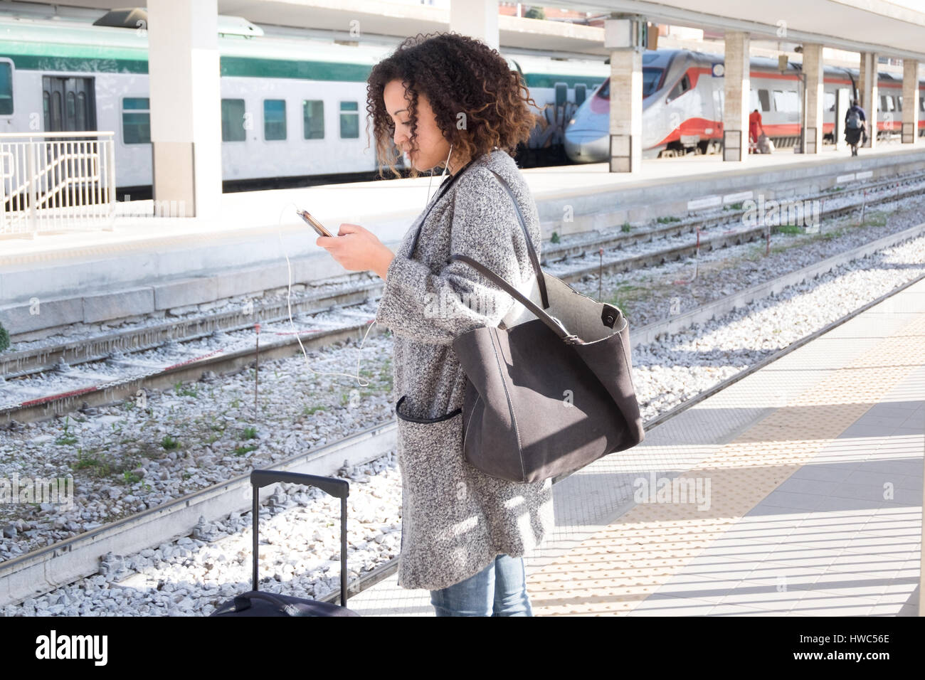 Woman waiting for the train hi-res stock photography and images - Alamy
