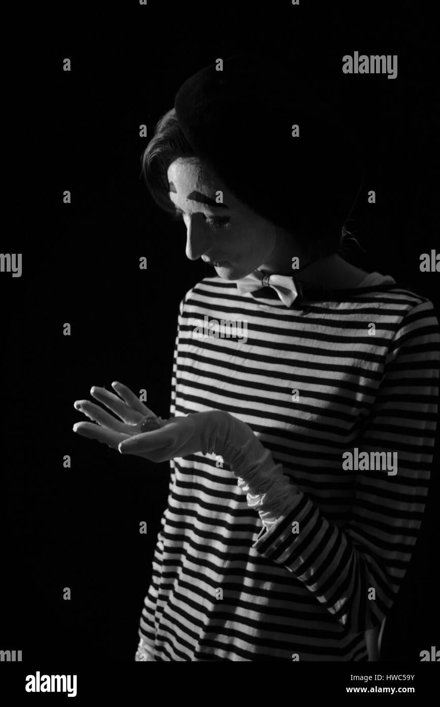 Emotional professional mime in stripped blacn and white shirt with ...