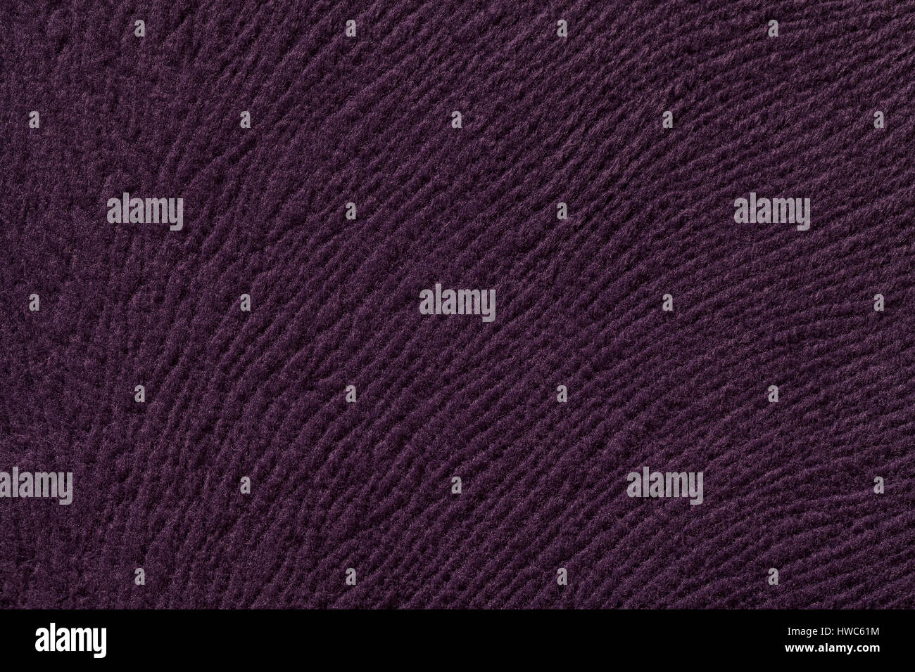 Dark purple background from a soft wool textile material closeup ...