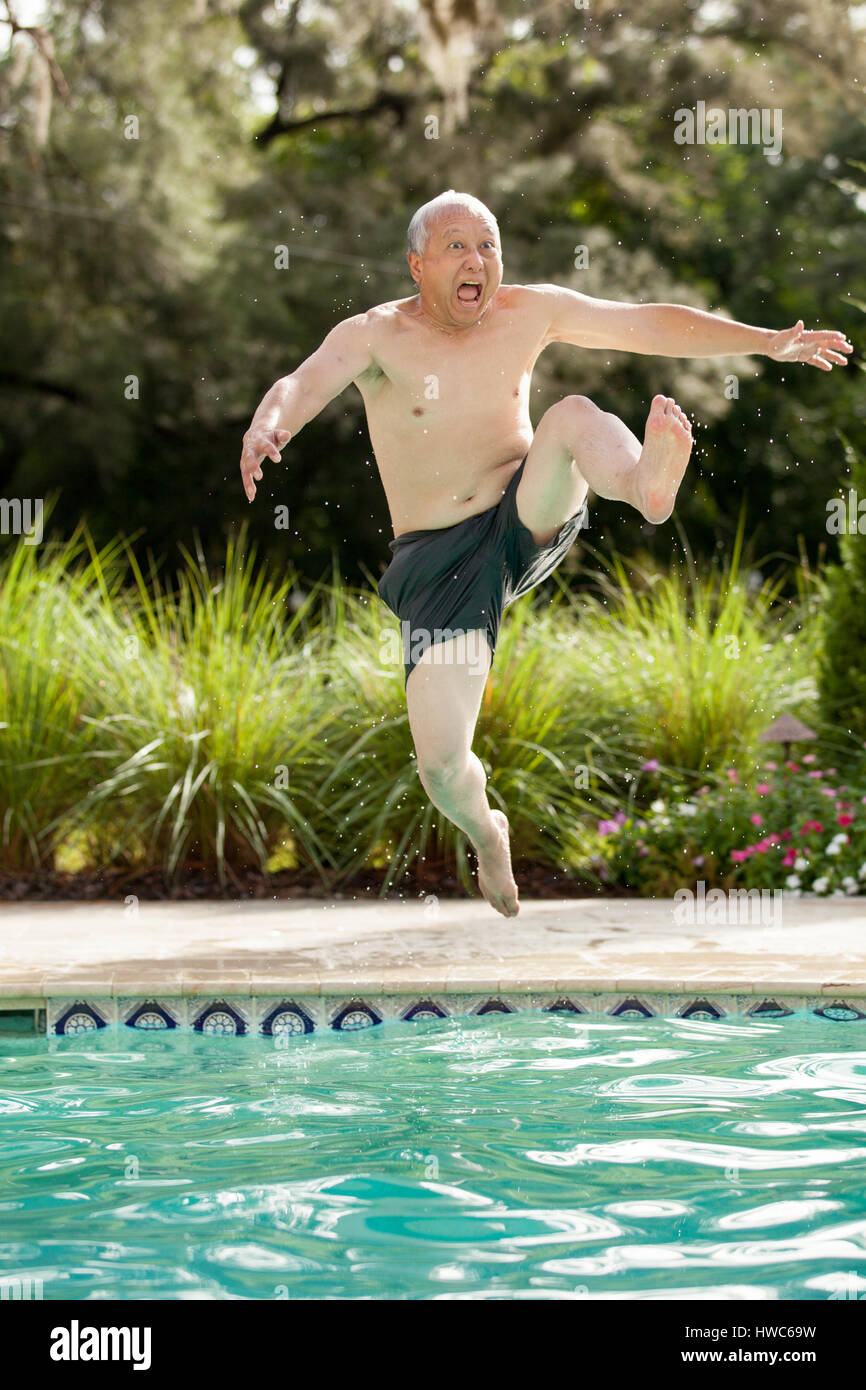 Senior playing in pool Stock Photo - Alamy