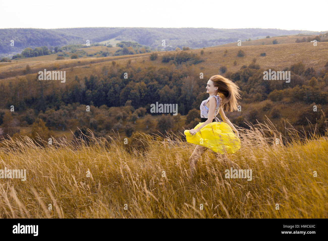 Happy smiling enjoying summer nature girl running in summer meadow ...