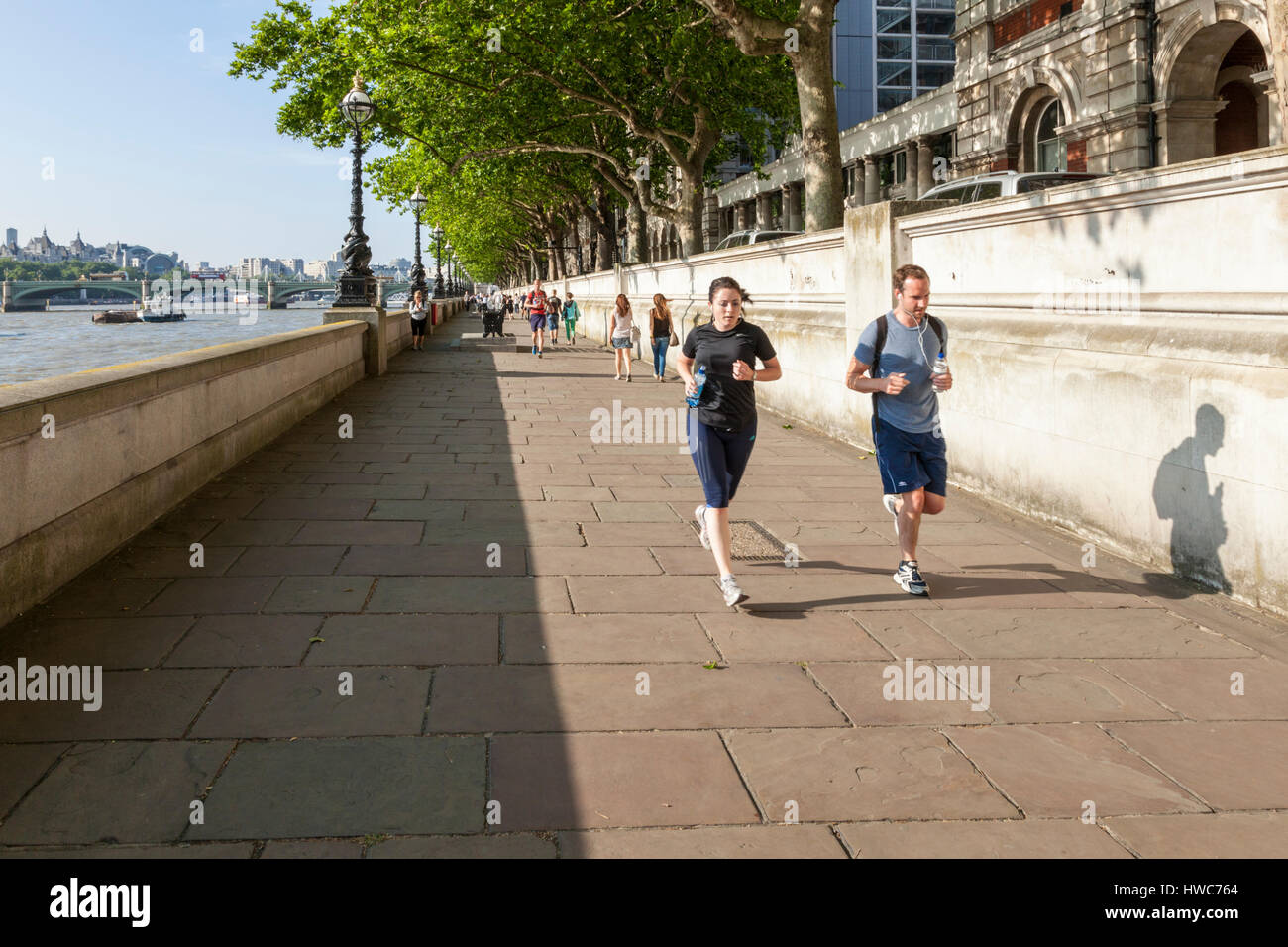 People running alongside the River Thames at Albert Embankment, London ...