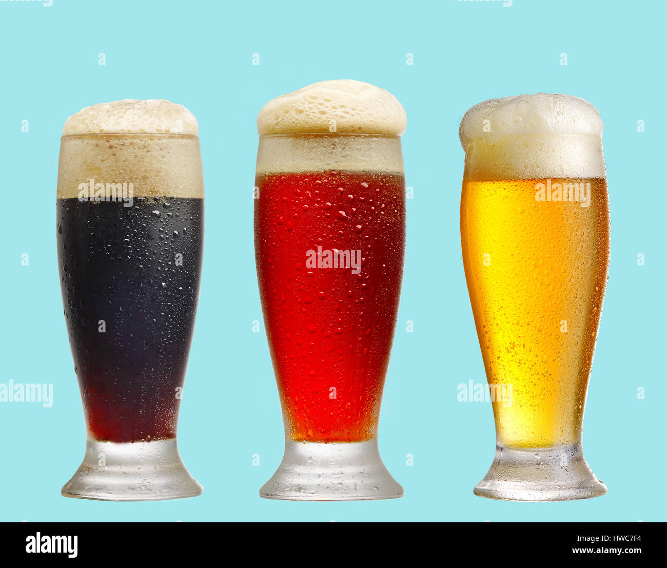 light, red and dark beer glasses on blue background Stock Photo - Alamy