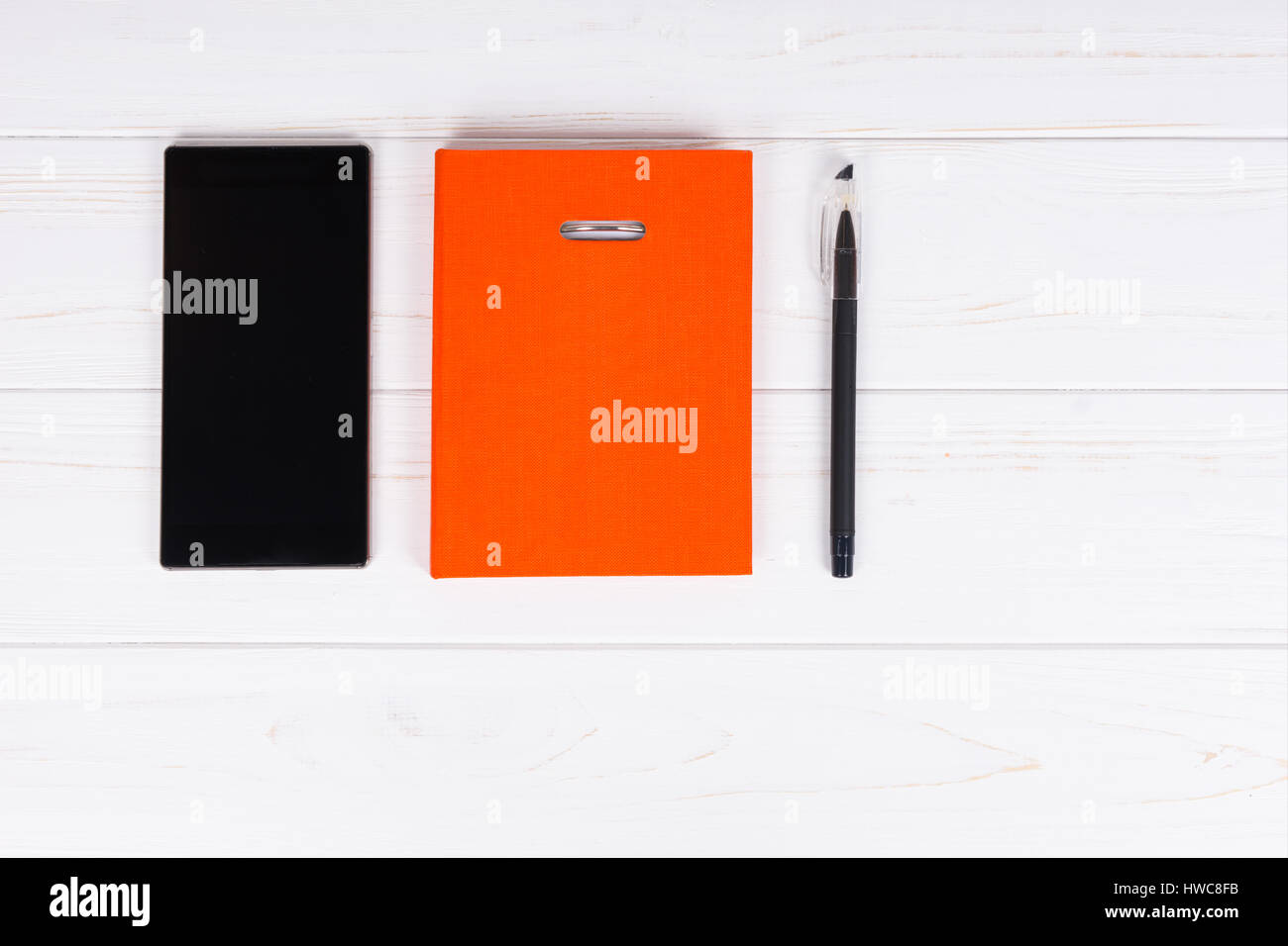 Orange diary with a pen for making appointments, organising a schedule ...