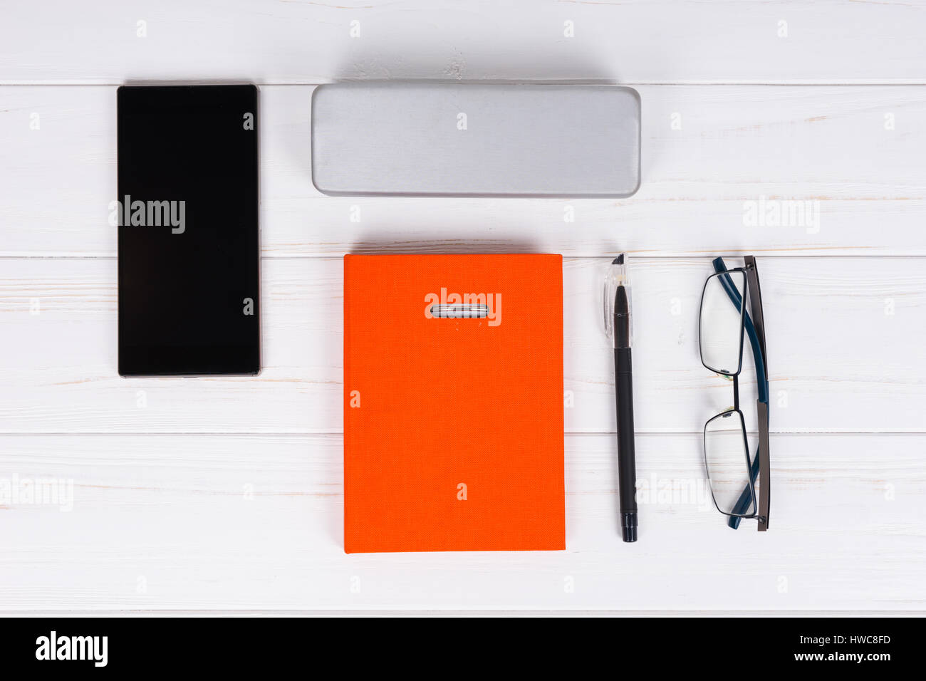 Orange diary with a pen for making appointments, organising a schedule ...