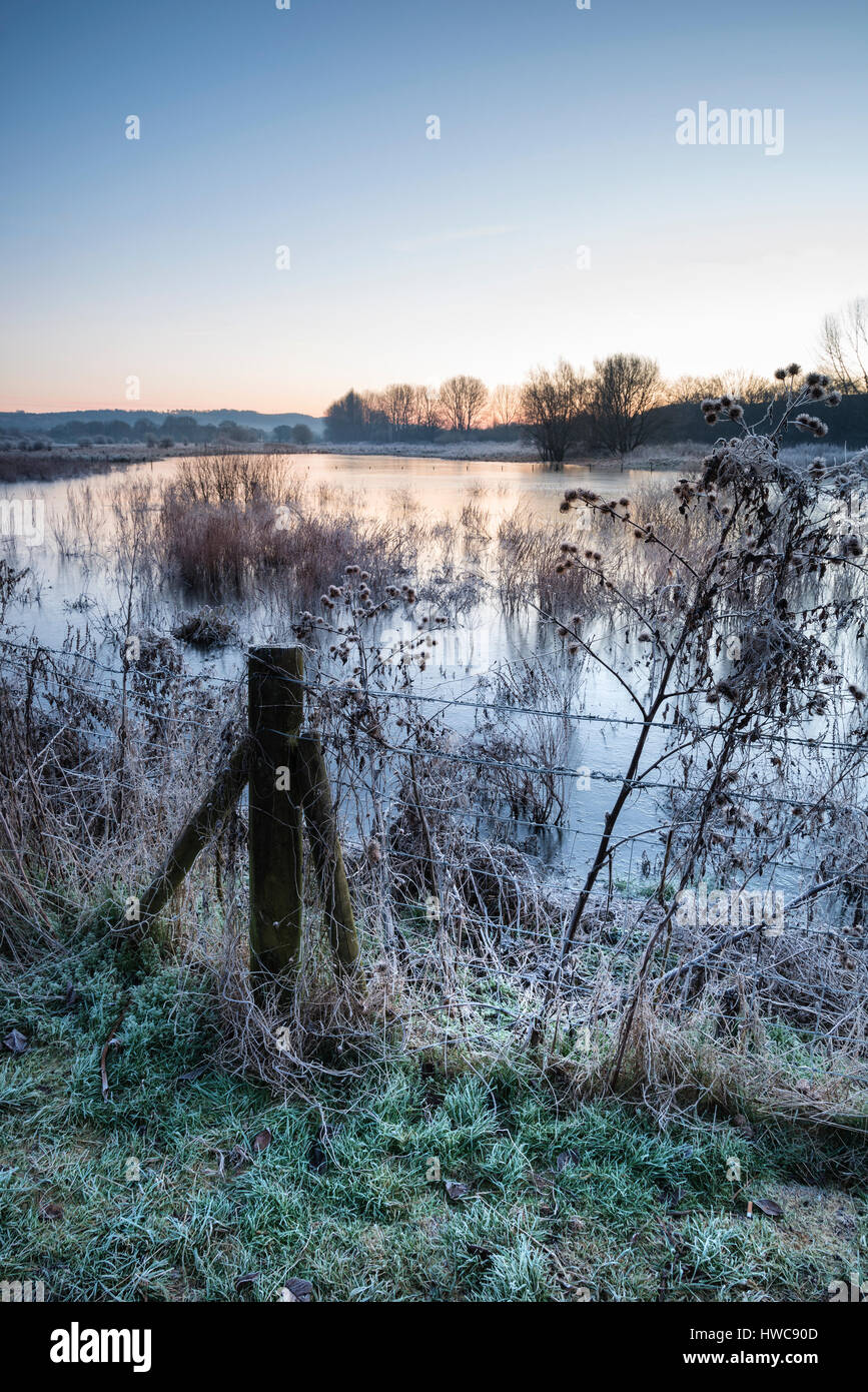 Beautiful English countryside lake image with frost and frozen lake in ...