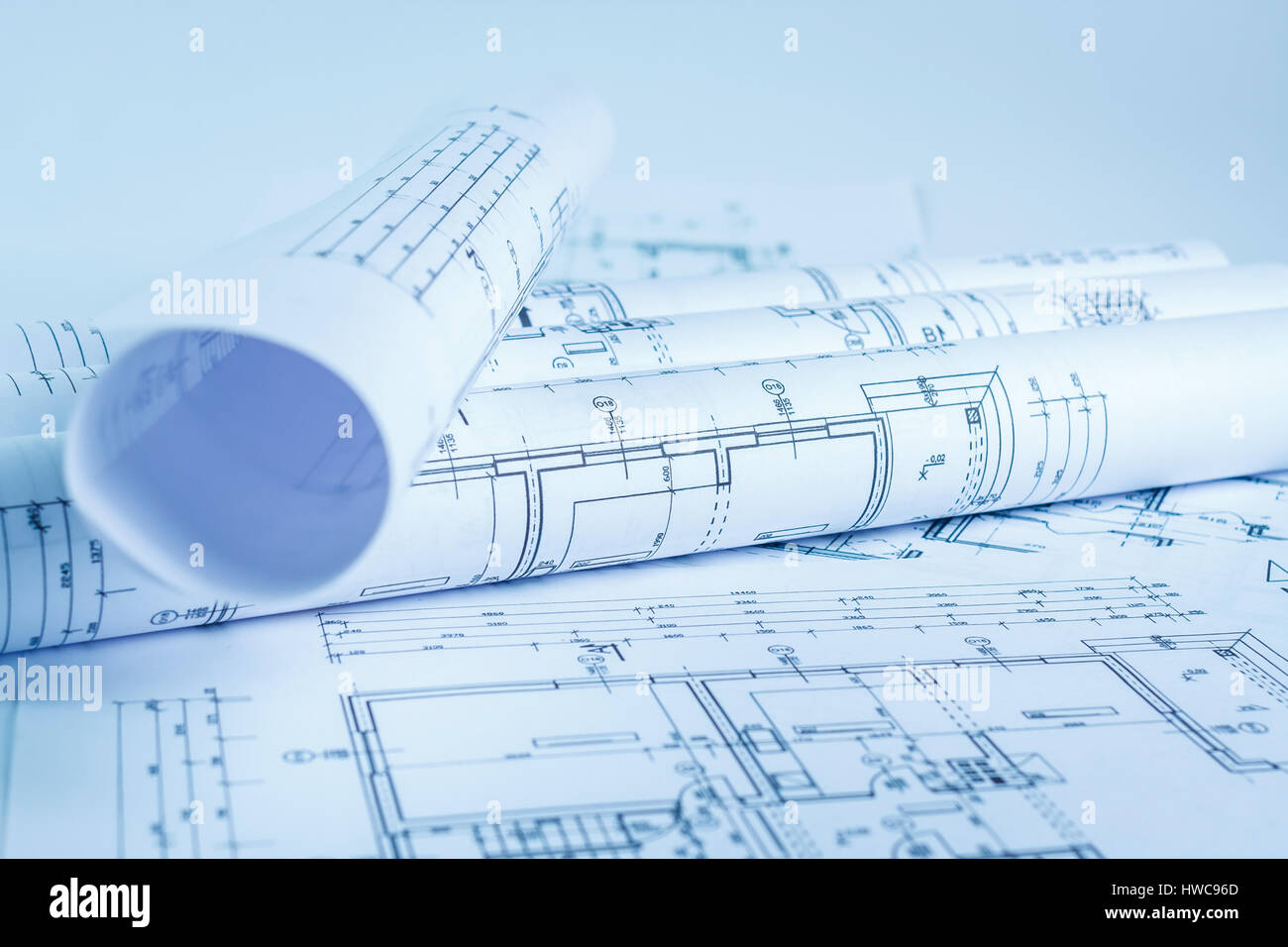 Architect rolls and house plans, close up Stock Photo - Alamy