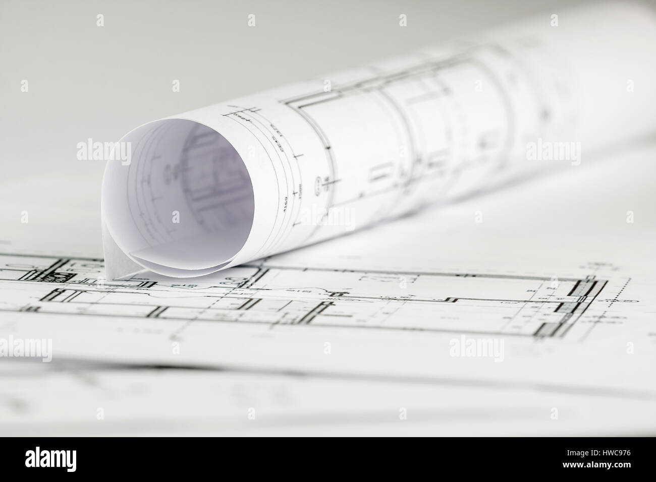 Architect rolls and house plans, close up Stock Photo - Alamy