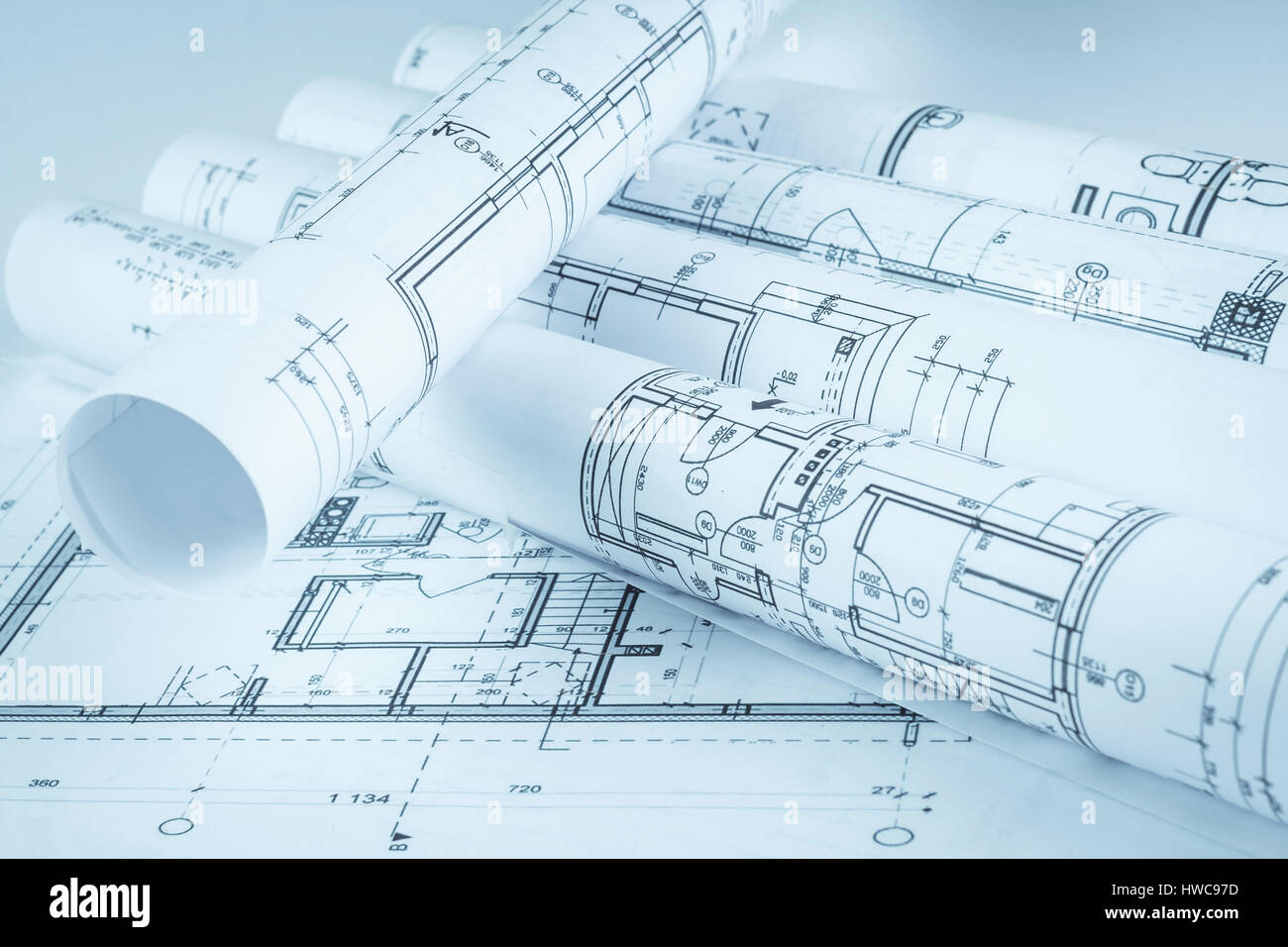 Architect rolls and house plans, close up Stock Photo - Alamy