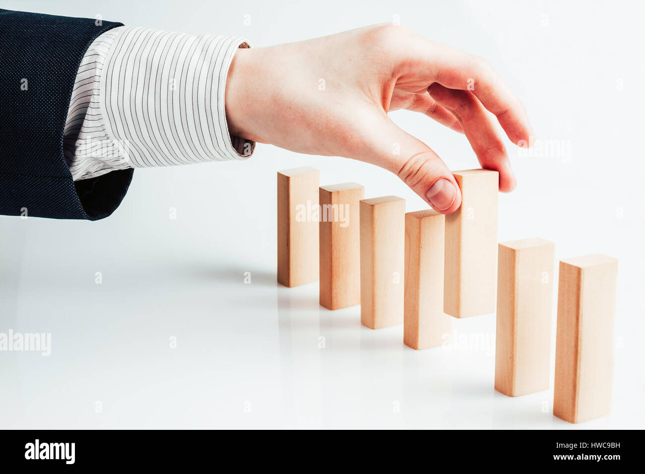 Domino effect hand finger push hi-res stock photography and images - Alamy