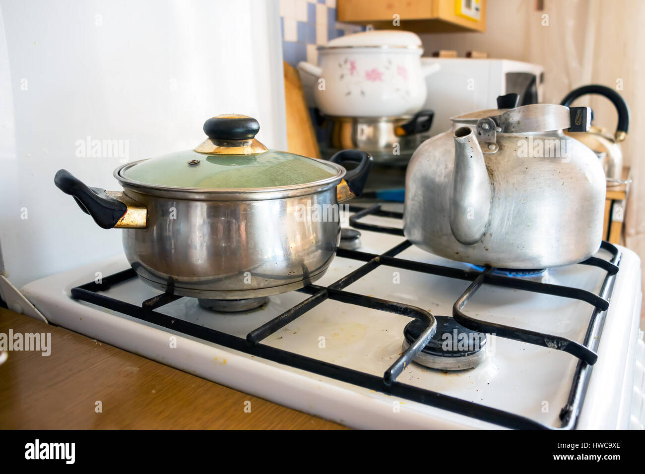 Pot and kettle on a gas stove 2 Stock Photo - Alamy