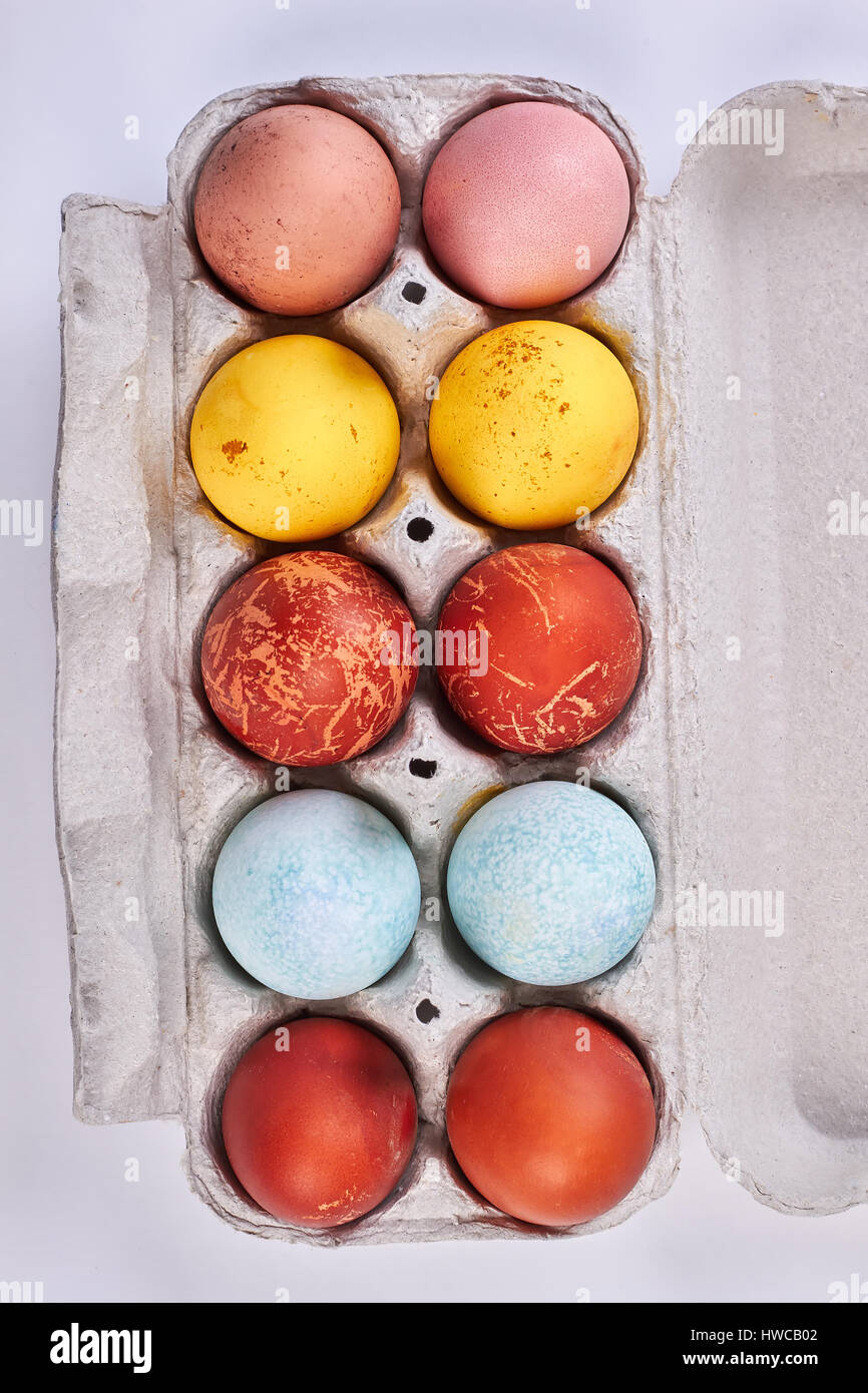 Multi colored eggs in container Stock Photo - Alamy
