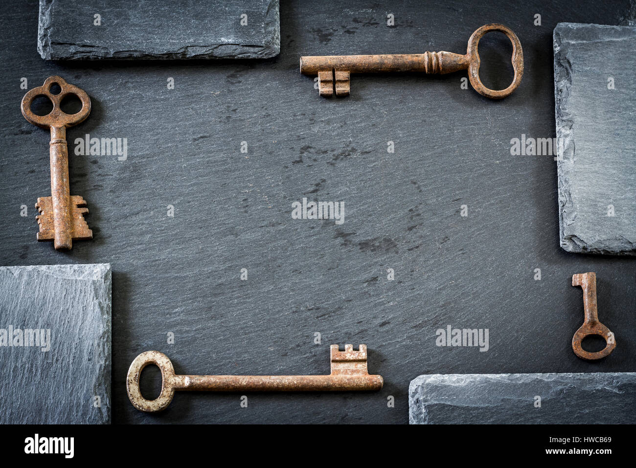 Old, rusty keys on the stone table Stock Photo - Alamy