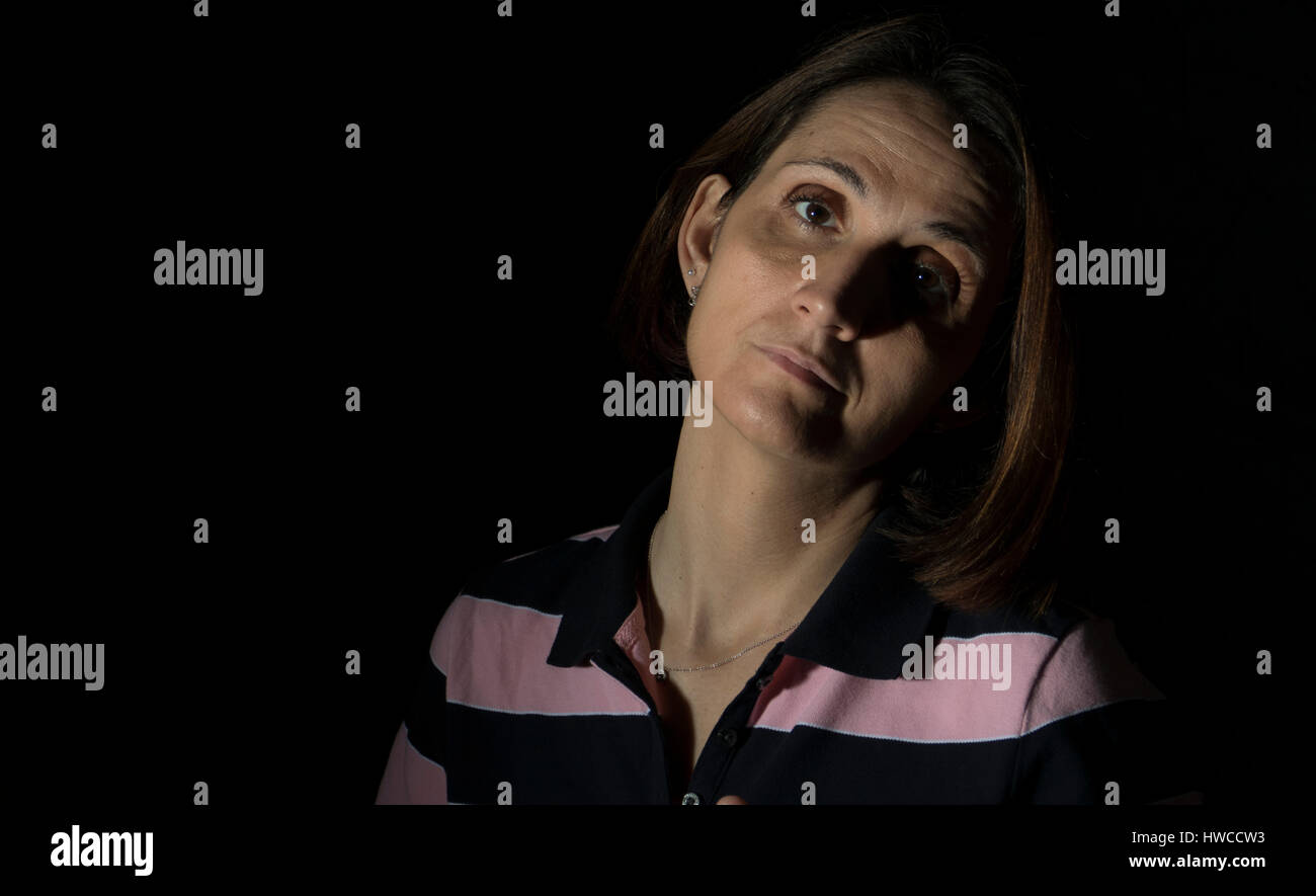 Young woman potrait isolated on black background Stock Photo - Alamy