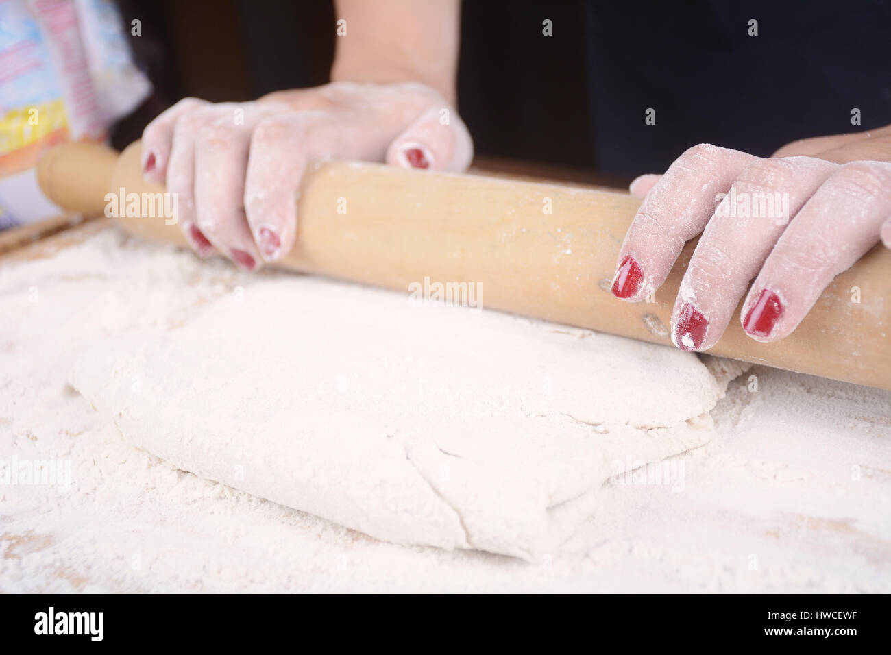 Close-up of woman rolling dough with rolling pin. Cooking concept Stock ...