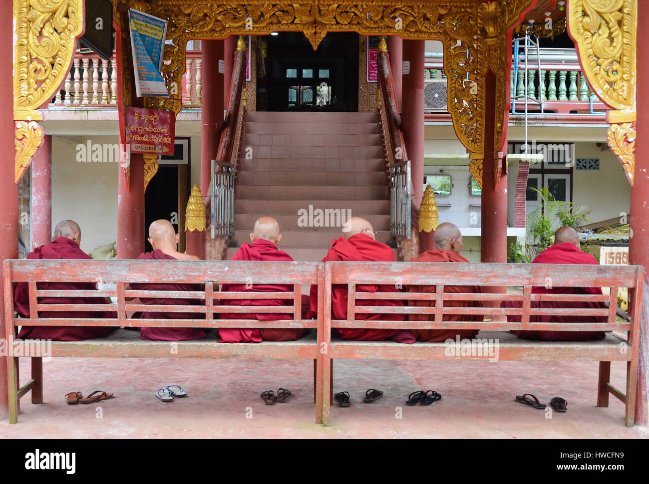 Old Buddhist monks squatting on a bench in front of a monastery Stock ...