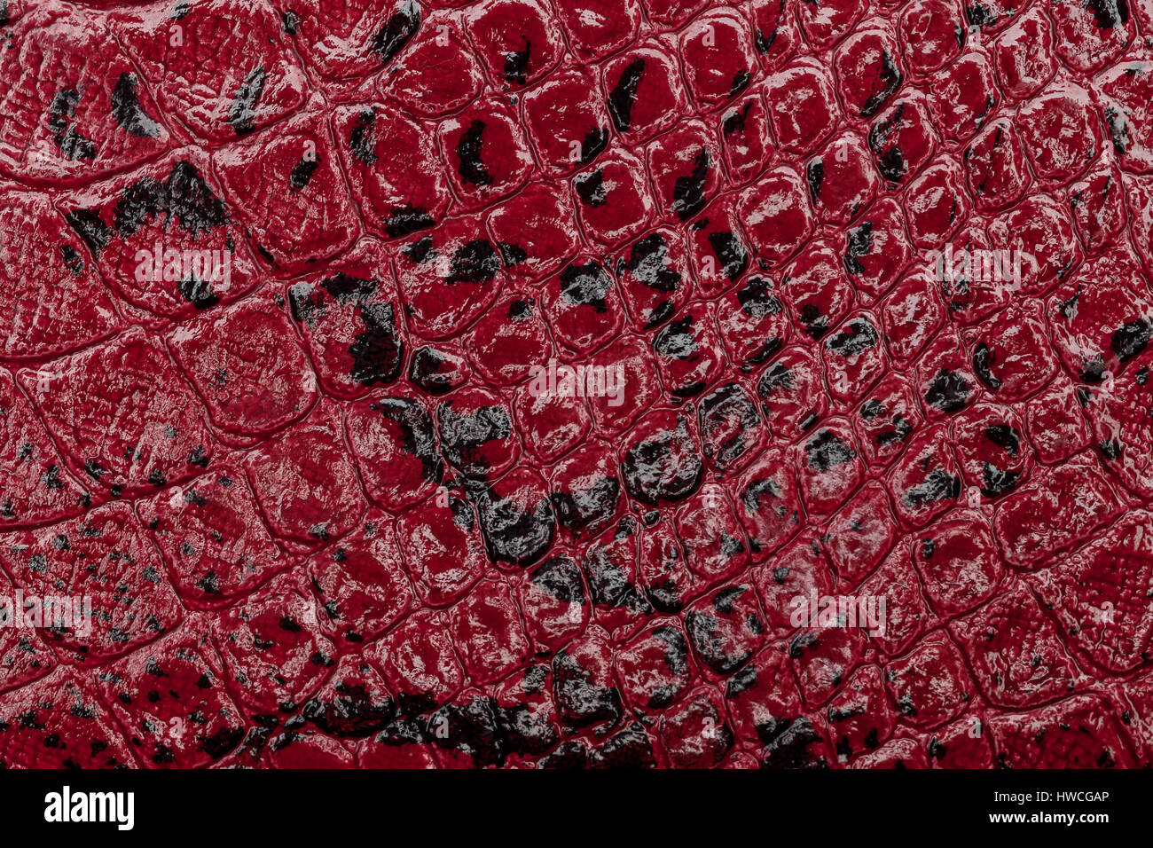 Red leather texture background. Closeup photo. Skin reptiles such as ...
