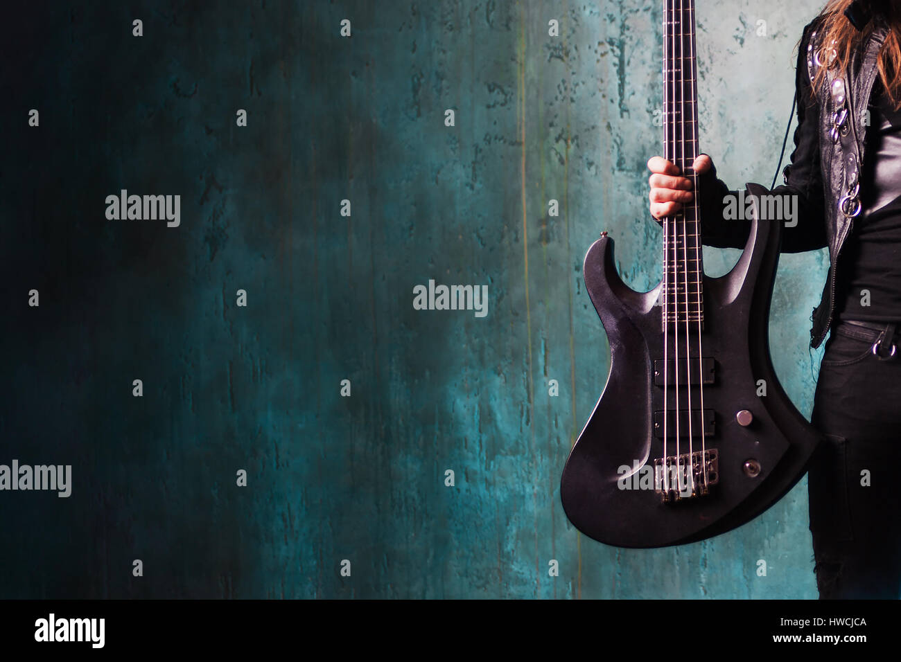 Man in black leather holding a guitar. Rocker and metalhead, youth ...