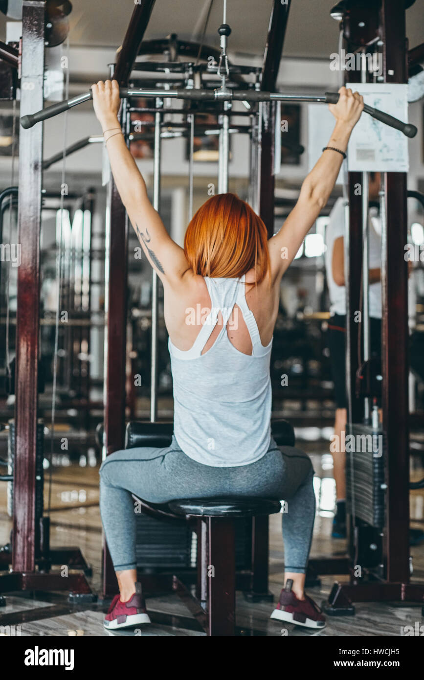 Woman training her back and shoulder with in a gym Stock Photo - Alamy