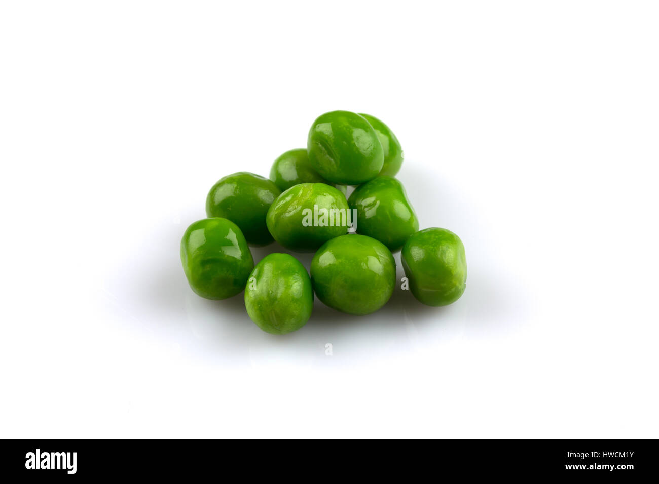 Green wet pea heap on white background Stock Photo - Alamy