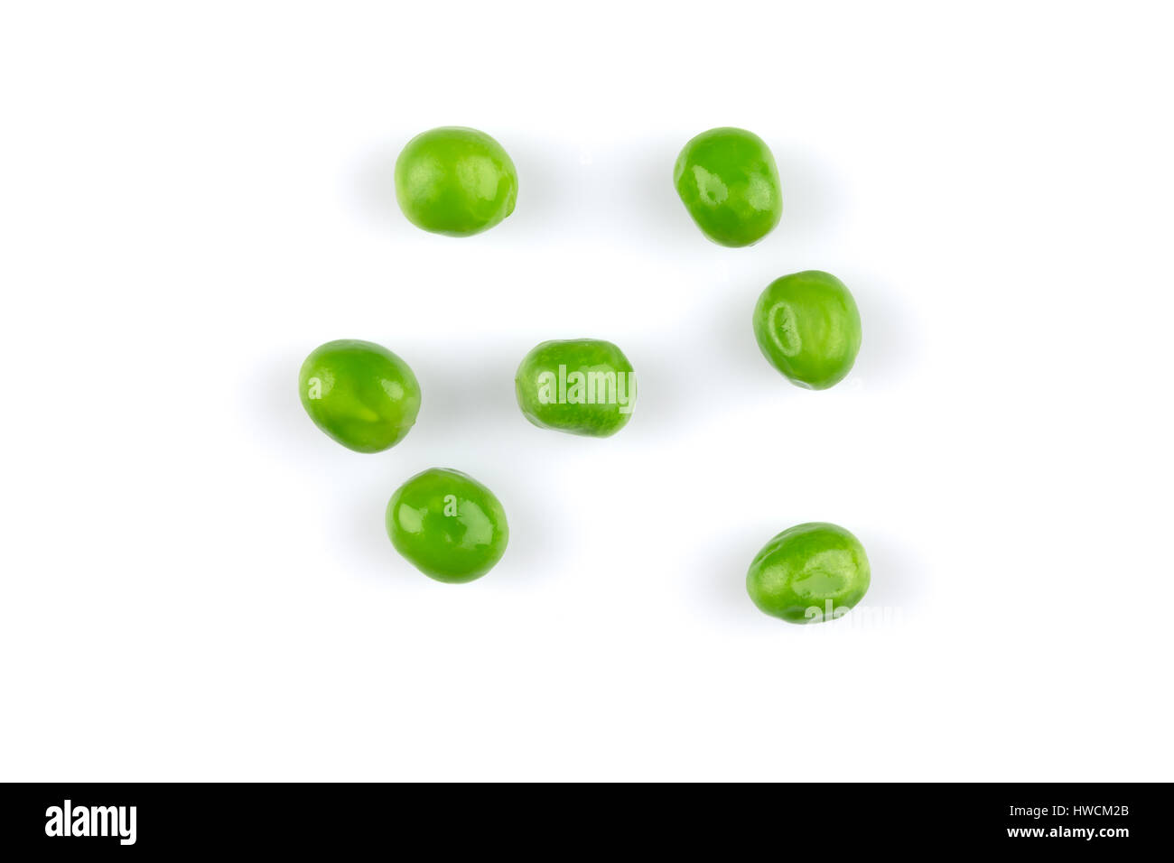 Pile of green wet pea isolated on white background Stock Photo - Alamy