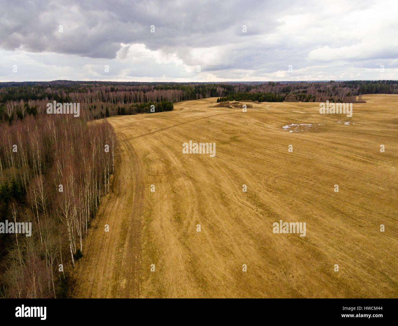aerial view of rural area with fields and forests in cloudy spring day ...