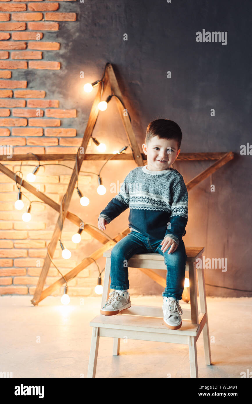 little boy sitting on a chair Stock Photo - Alamy