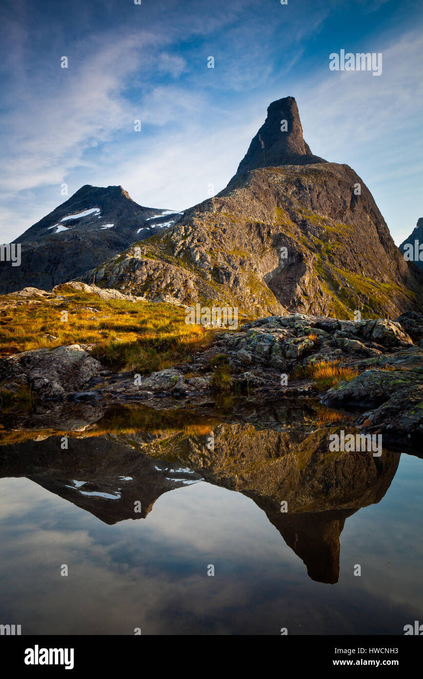 Autumn golden hour evening sunlight on the mountain peak Romsdalshorn ...