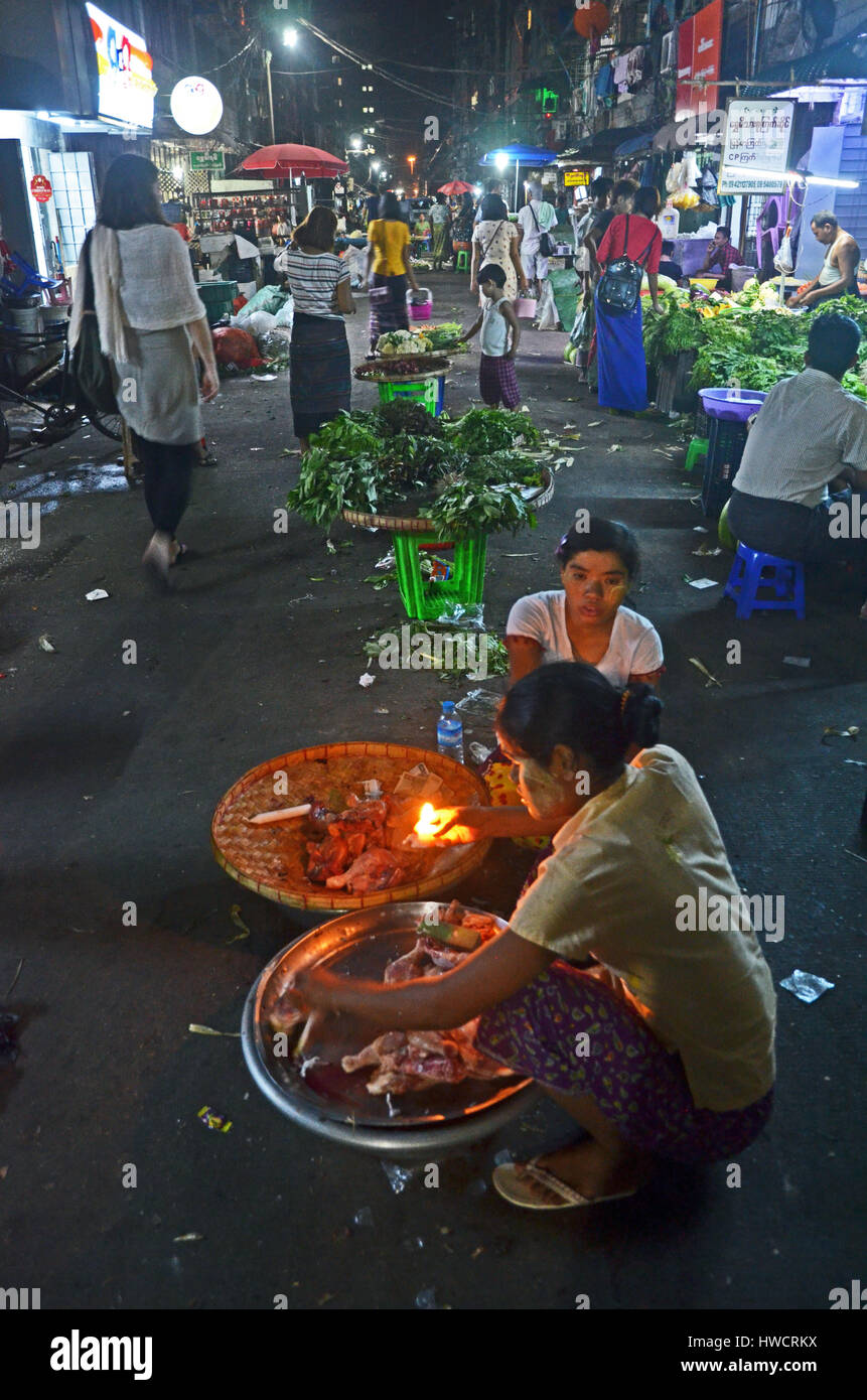 Women sell chicken at a night market in Yangon, Myanmar Stock Photo - Alamy
