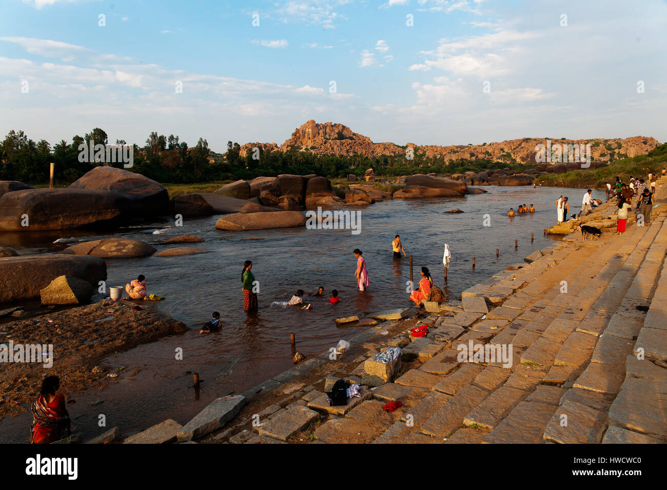 Indian people refreshing themselves on the waters of Tungabhadra river ...