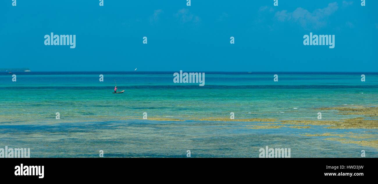 Tanzania, Zanzibar, Chapwani, fisherman in his boat in turquoise waters ...