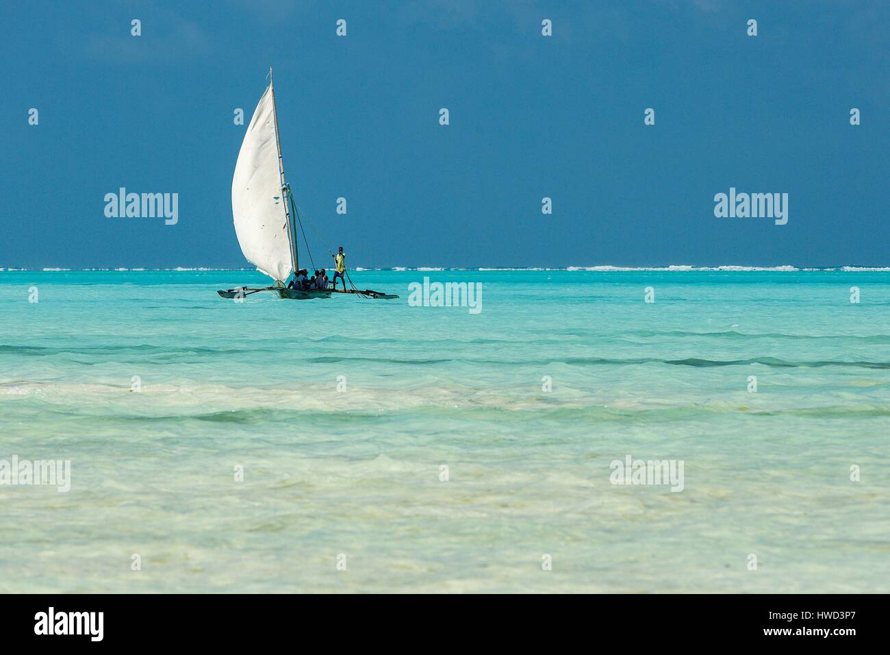 Tanzania, Zanzibar, Jambiani, boat sailing in turquoise waters Stock ...