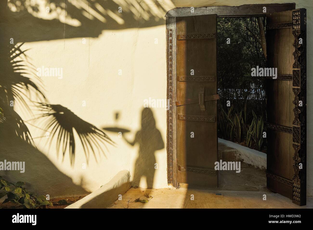 Tanzania, Zanzibar, Kendwa, Kilindi Hotel, waitress shadow carrying a ...