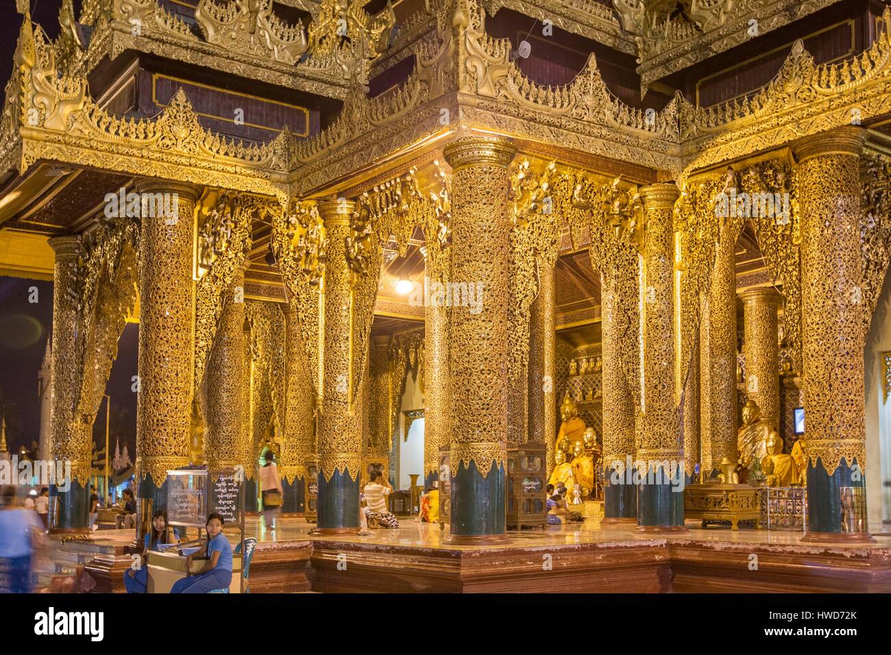 Myanmar (Burma), Rangoon, people praying in tazaung at Shwedagon pagoda ...