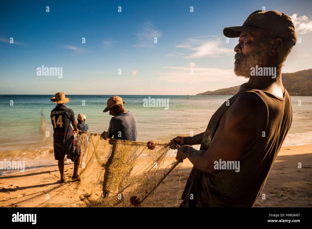 Seychelles, Mahe Island, Beau Vallon, fishermen pulling back their ...