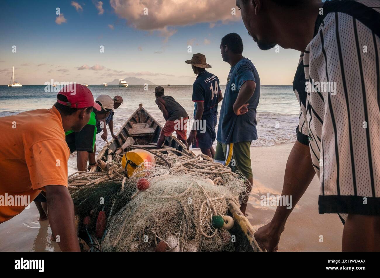 Seychelles, Mahe Island, Beau Vallon, group of fishermen taking sea in ...