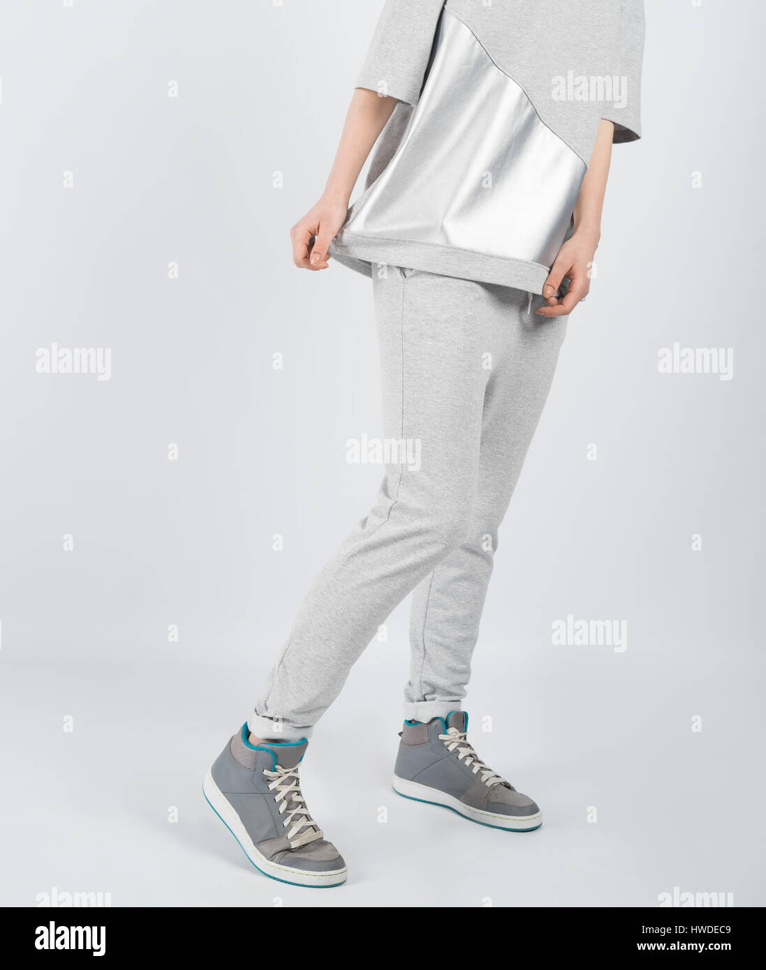 Lower body section of a young beautiful girl wearing grey clothes and ...