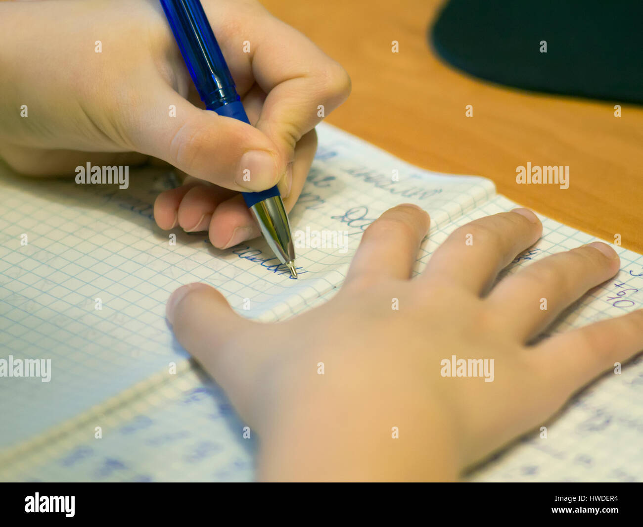 The child writes in a notebook close-up Stock Photo - Alamy