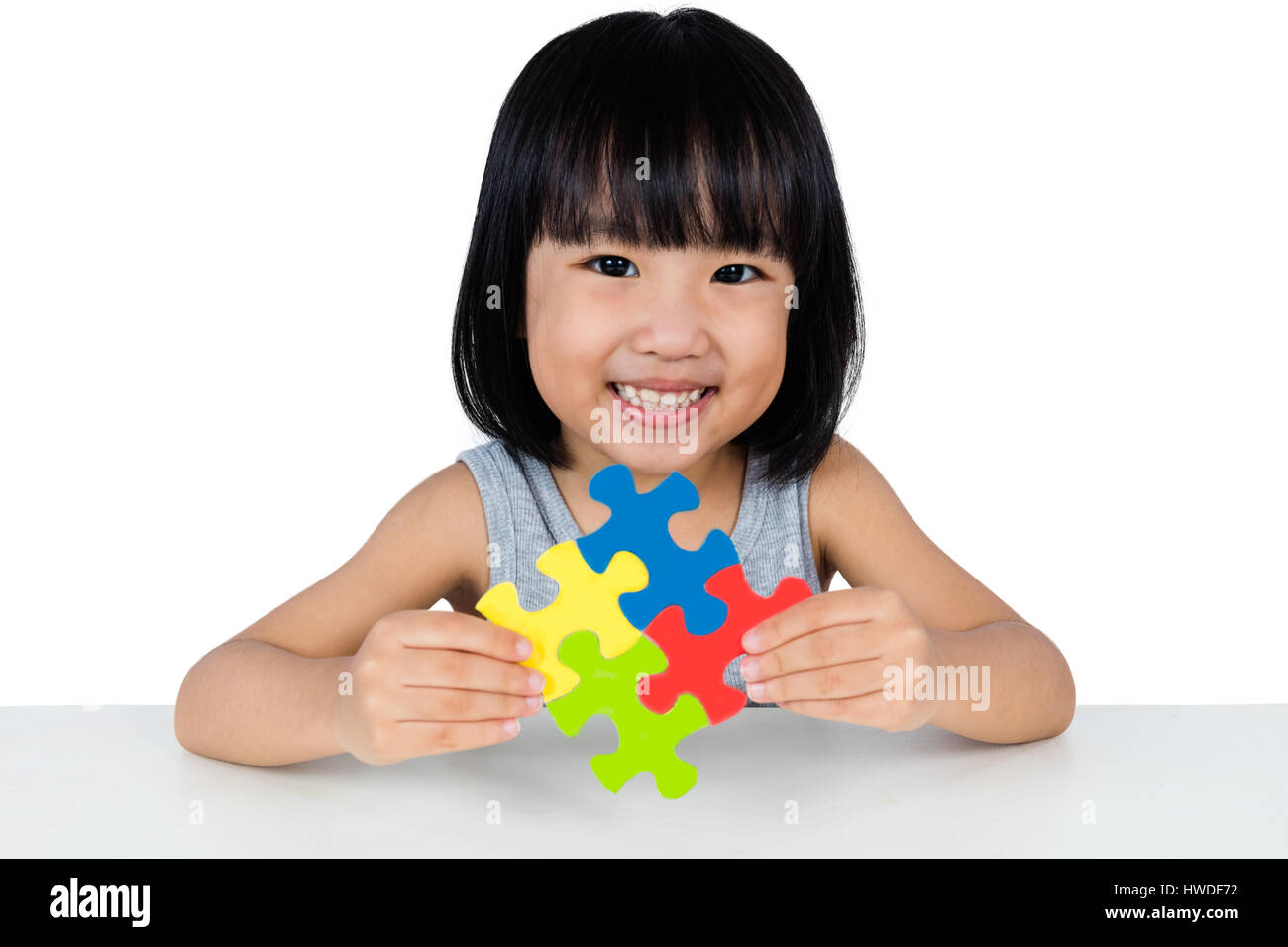 Asian Little Chinese Girl Playing Colorful Puzzle in isolated White ...