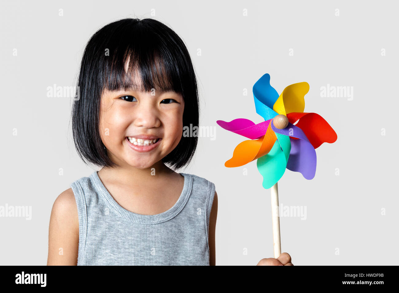 Asian Little Chinese Girl Playing Colorful Pinwheel in isolated White ...