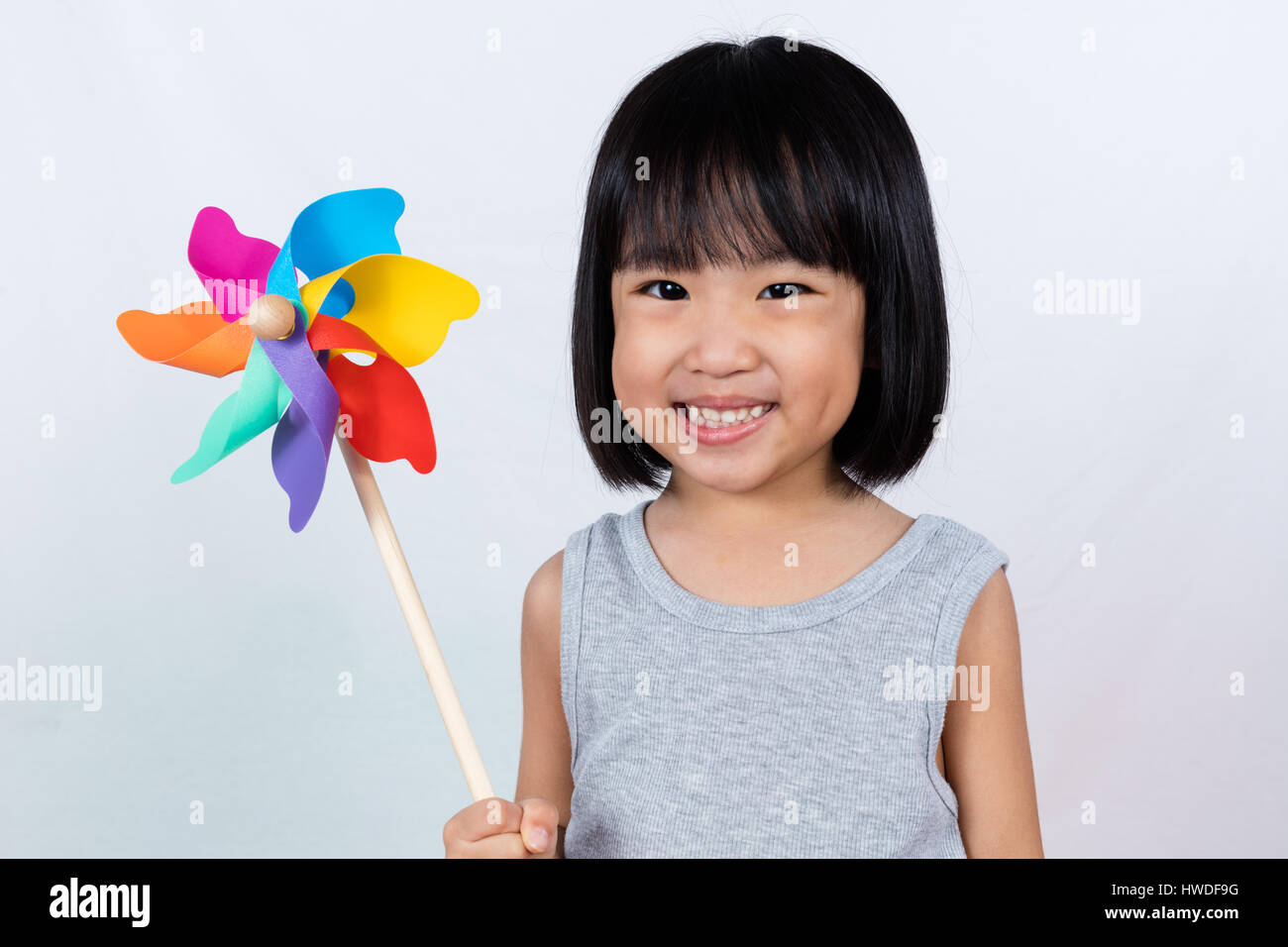Asian Little Chinese Girl Playing Colorful Pinwheel in isolated White ...