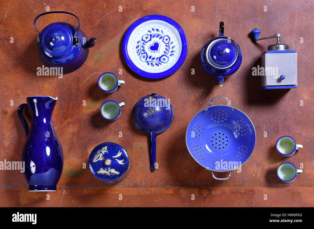 Assorted collection of blue kitchenware and culinary tools on a wooden ...