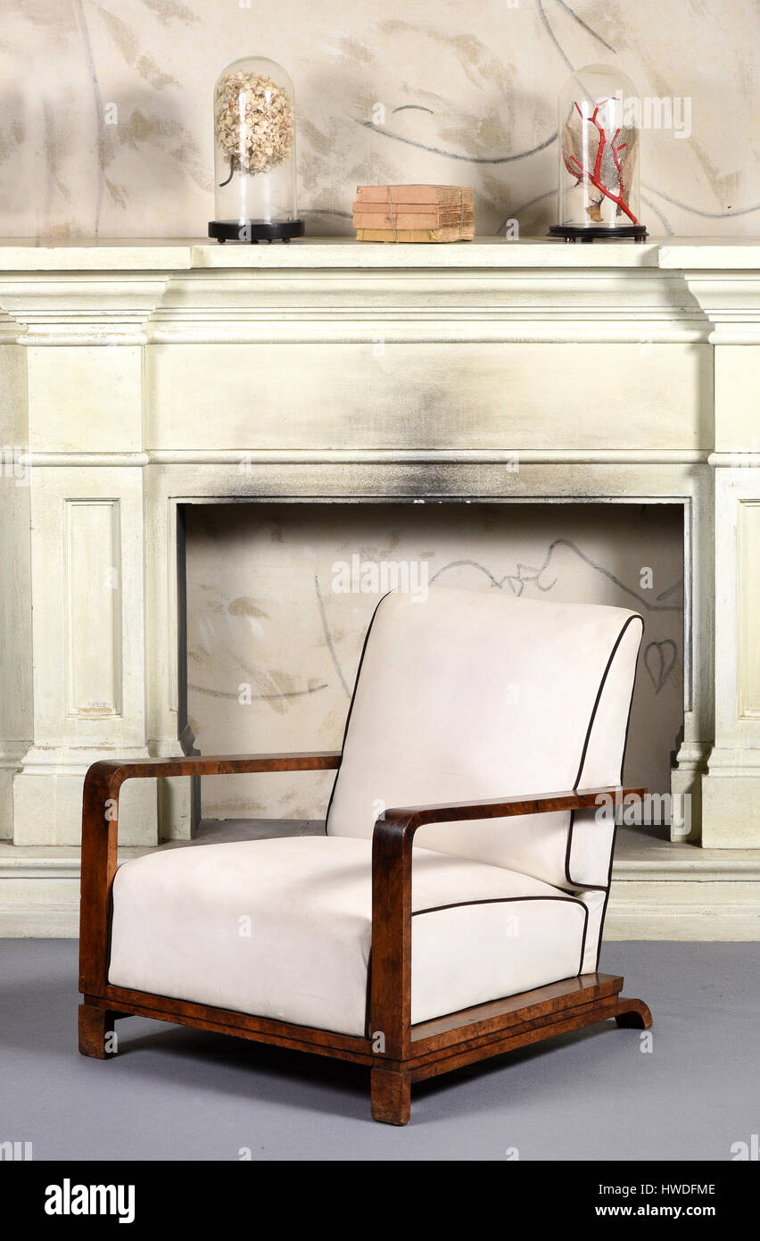 Art Deco style upholstered white armchair with typical angular wooden ...