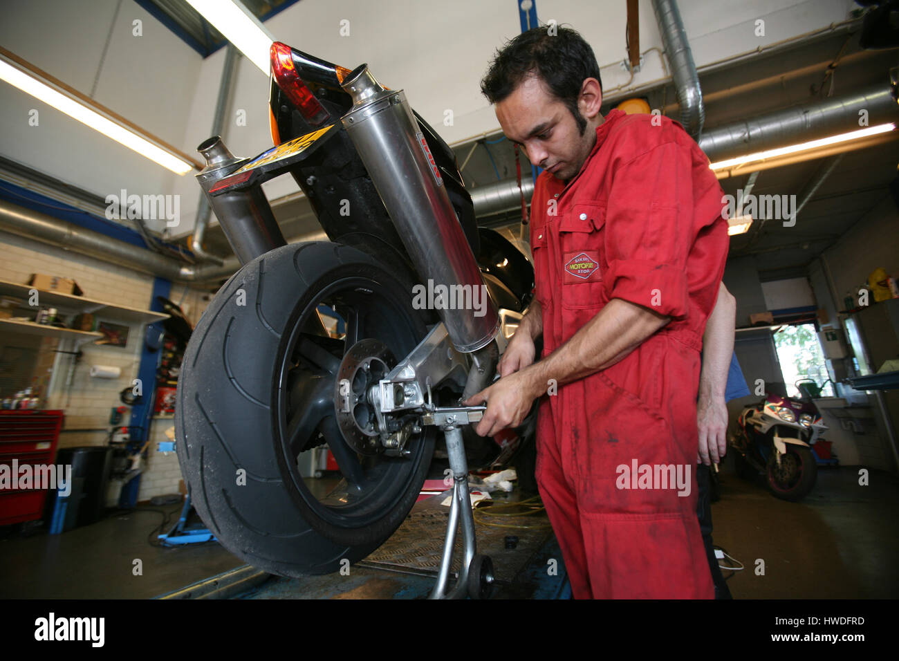 motor mechanic at work, maintaining engines in a workshop Stock Photo ...