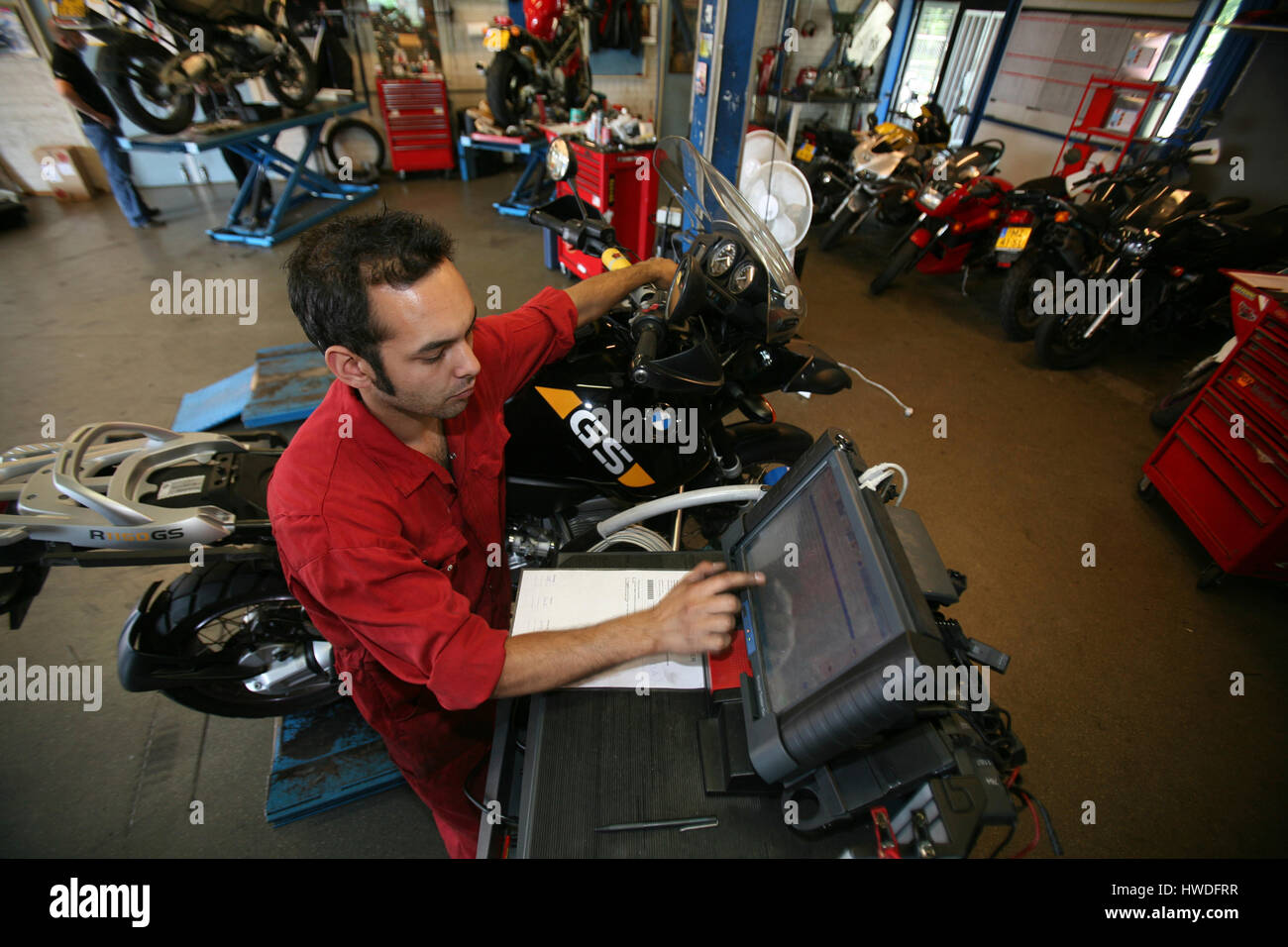 motor mechanic at work, maintaining engines in a workshop Stock Photo ...