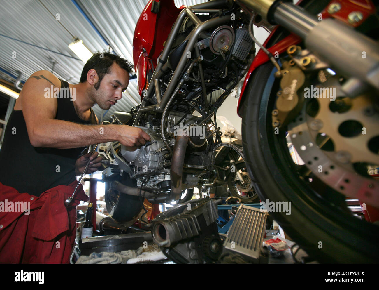 motor mechanic at work, maintaining engines in a workshop Stock Photo ...