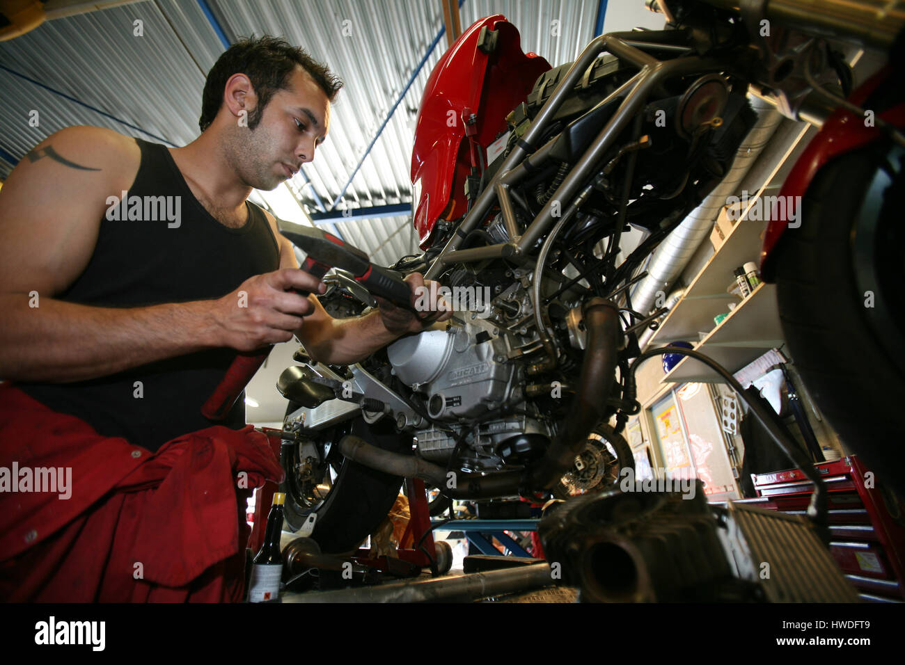 motor mechanic at work, maintaining engines in a workshop Stock Photo ...