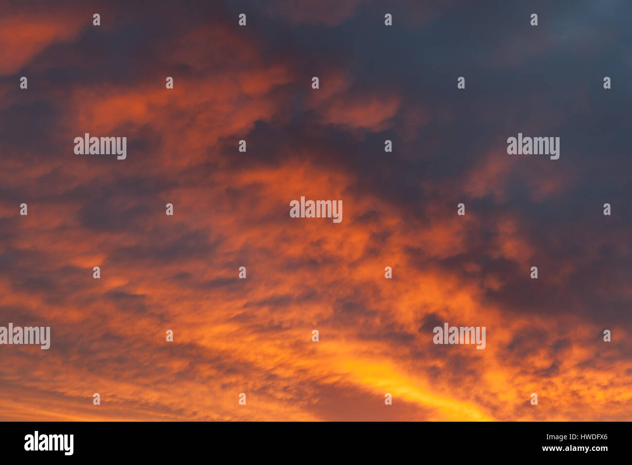 Fiery vivid sunset sky clouds Stock Photo - Alamy